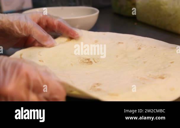 A professional chef is cooking Mexican food in restaurant, tacos and ...