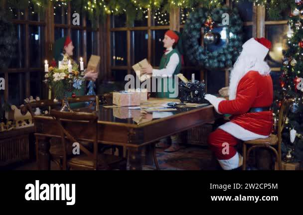 Santa Claus is writing a letter on the typewriter and watching as the ...