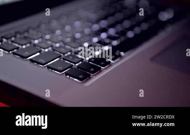 Backlit Laptop Keyboard In A Dark Room Closeup Of Coding On Screen Man Hands Coding Html And