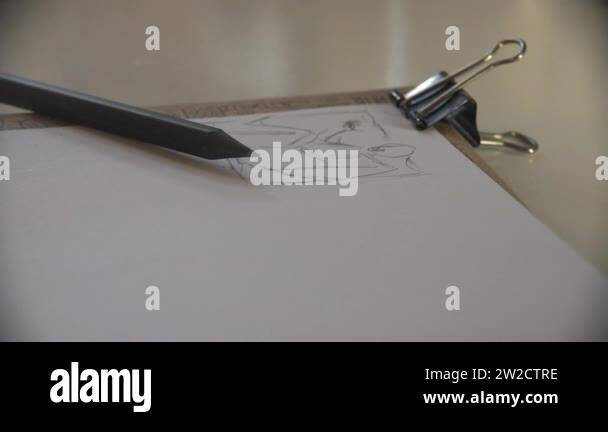 Macro view. Graphite Pencil lies on sheet of white paper on which ...