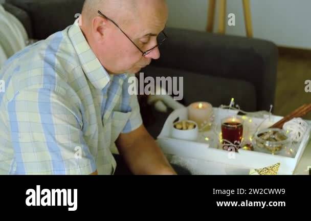 an elderly man looks through his old photographs of 1960-1965, the ...