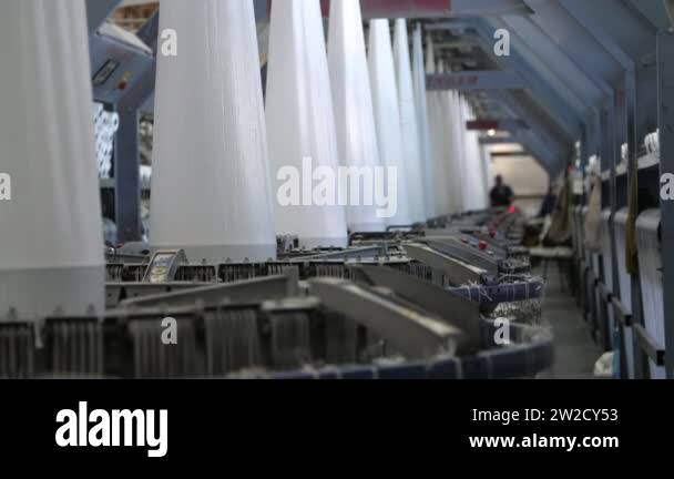 Line of conical columns rotating and making plastic canvas for agro ...
