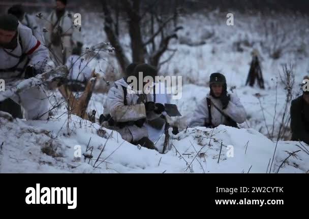 German soldiers in white camouflage suits in the winter, digging in the ...