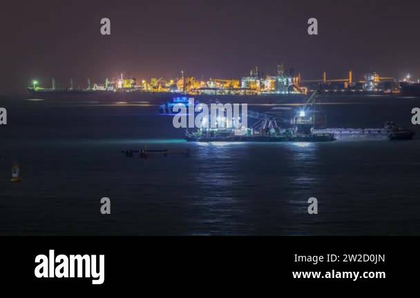 Singapore Marina Barrage with cargo ships waiting to enter one of the ...