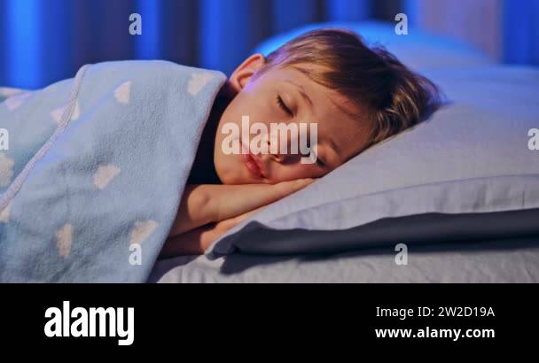 4k footage of a sleeping child in bed. 8 years old boy sweetly sleeping ...