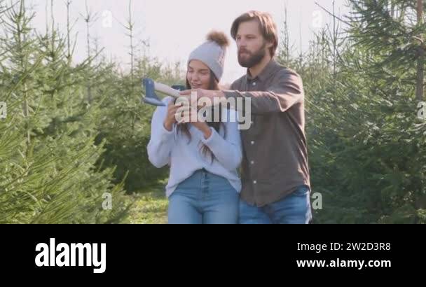 Handsome smiling bearded man with ax offering different versions of fir ...