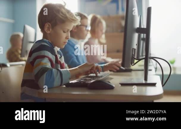 Elementary School Computer Science Classroom: Smart Little Boy Uses ...