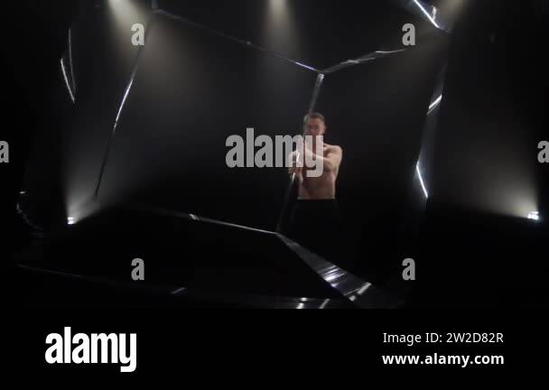 circus male muscular performer making tricks with juggling cube props ...