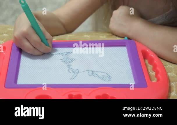 Little girl learns to draw on the blackboard. Development of kid motor ...