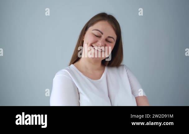 Beautiful plus size girl model smiling in camera with friendly smile ...