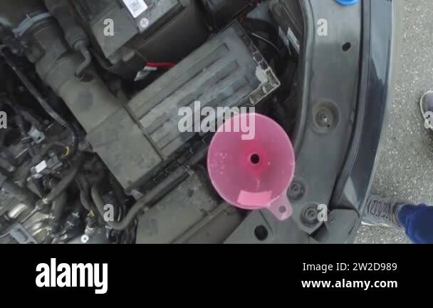 Pouring exhaust additives for diesel engines into the tank for adBlue ...