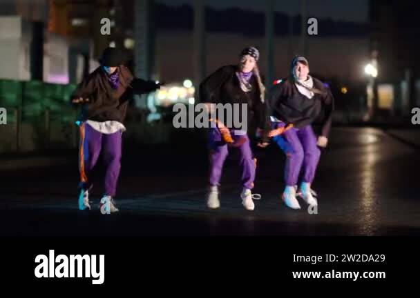 Trio of young beautiful women dancing hip hop, freestyle on the street ...