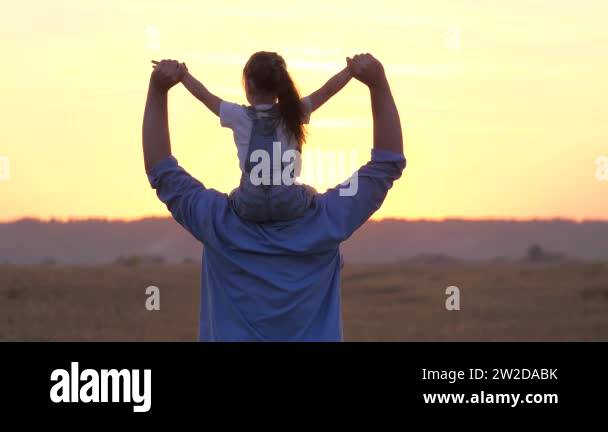 baby and daddy dream of becoming a pilot. child sits on fathers neck ...