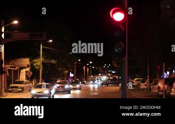 Cars stopping at a stop sign waiting to turn green so they can pass ...