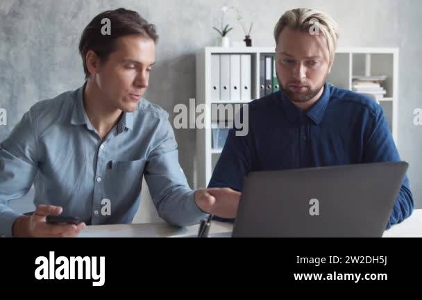 Two business persons are work together in modern office. Team of ...