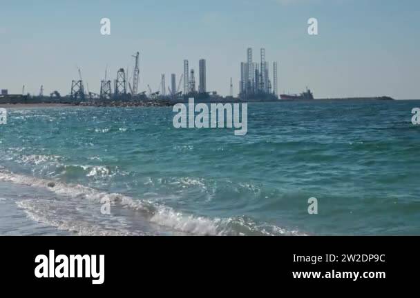 Construction of oil production towers in the Persian Gulf. Desert ...