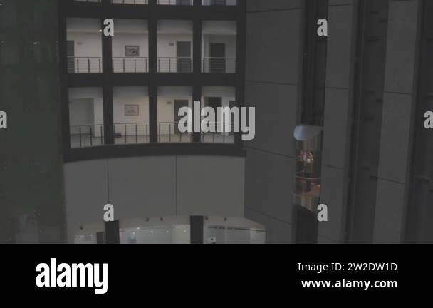 Woman rises in Elevator. Stock. Woman rises in modern glass Elevator in multi-storey residential ...