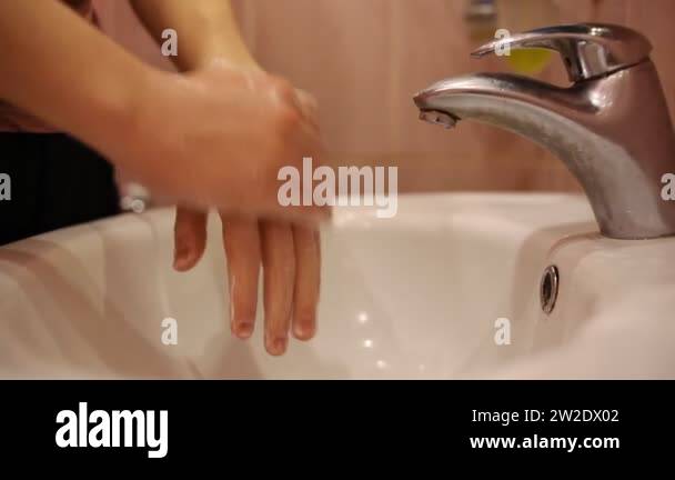 Washing hands with soap and warm water to prevent the coronavirus ...