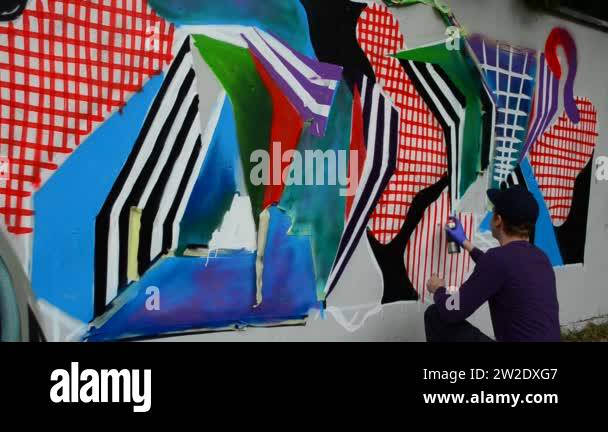 Process of creation of graffiti, fence. The artist draws graffiti Stock ...