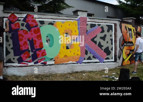 Process of creation of graffiti, fence. The artist draws graffiti Stock ...