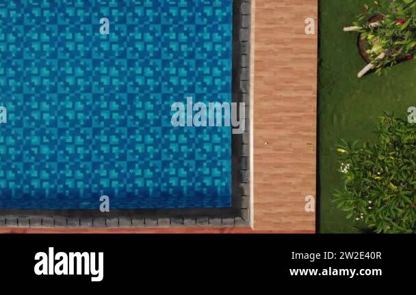 Aerial blue swimming pool with crystal clear water with top view under ...