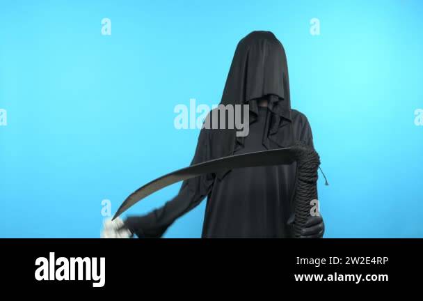 man dressed as a grim reaper holding money in his hands, blue ...