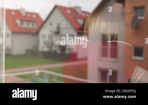 Husband and wife pensioners are dancing behind glass in their house. A ...