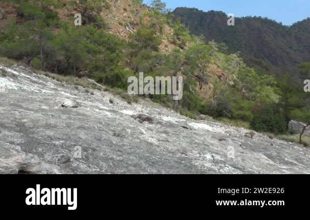 Flame of Methane Underground Emerges From Crack Between Rocks and Burns ...