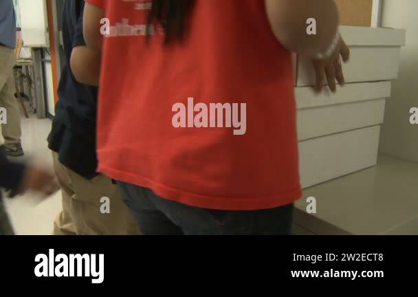 Grammar school students getting boxes from back of classroom Stock ...