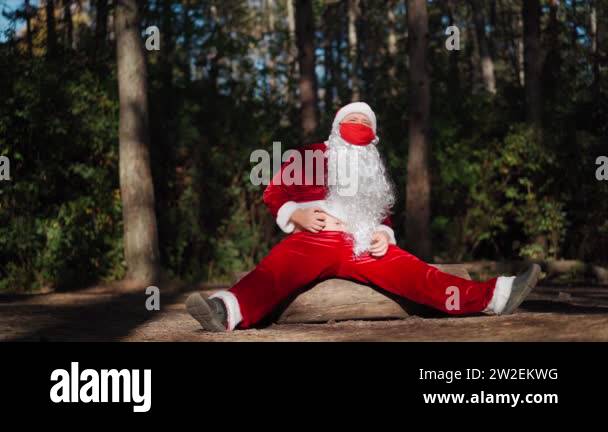 Sad lonely guy dressed in a santa claus suit with a protective medical ...