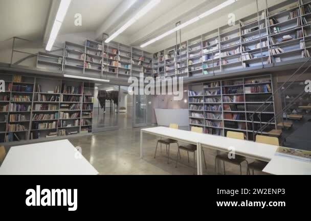 Bookshelves in library with many books. Public library interior. Modern ...