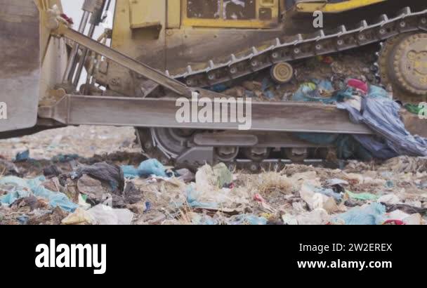 Side view close up of vehicle working and clearing rubbish piled on a ...