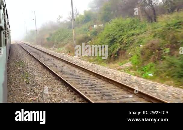 Indian Railways. Passenger train, by rail. Shot from window of last car ...