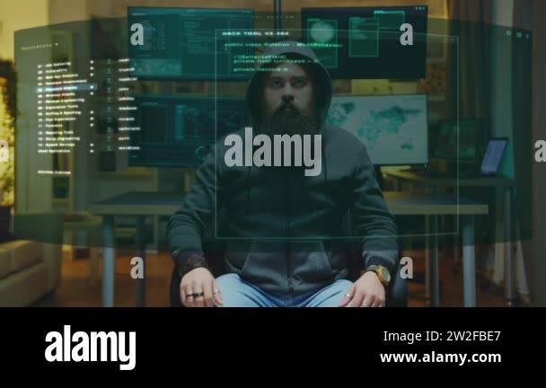 Bearded hacker working on virtual holograms display in front of him ...