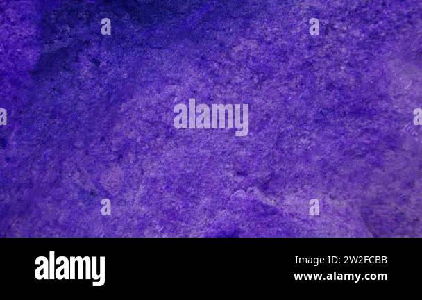 4K rain drop on heavy hard purple granite stone tile surface of cave ...