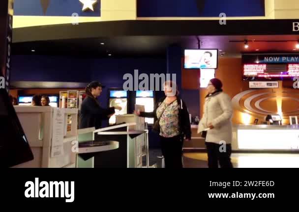 Worker receiving the movie ticket at cinema entrance Stock Video ...