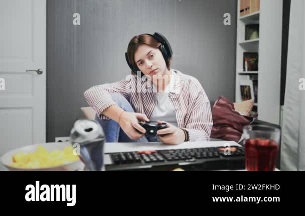 Boring Young Gamer Girl playing in Video Games on a Console with a ...