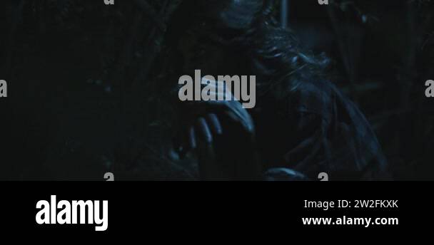 Scary zombie creature woman eating human hand in the woods. Close up ...