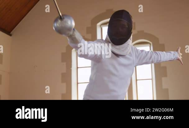 Low angle front view of a confident focused Caucasian male fencer ...