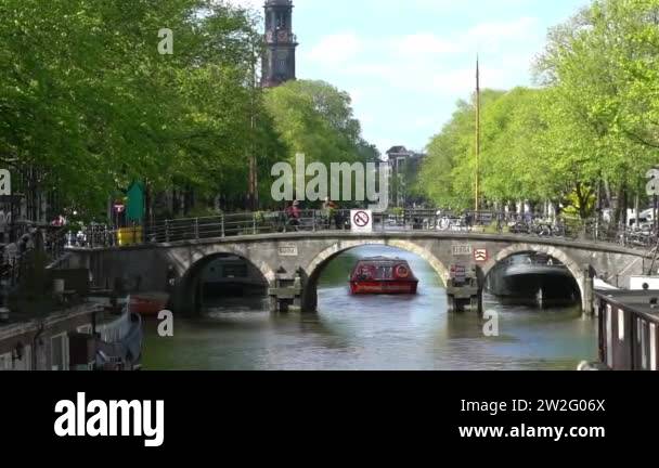 Amsterdam, Netherlands-13 May, 2019: Town houses and boat pass through ...