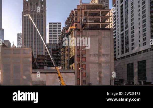 Chicago, IL - March 10th, 2020: A yellow construction crane hoists a ...