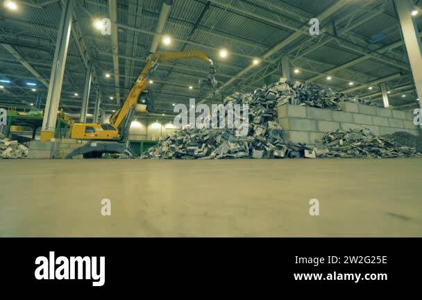 Mechanical vehicle is grabbing plastic waste. Waste, plastic trash ...