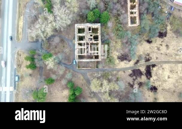 Descending to abandoned mansion ruins. Top down drone view with zoom in ...