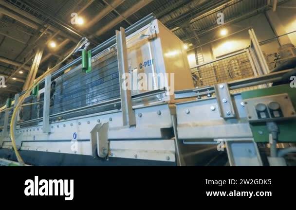 Conveyor machine located in the industrial unit. Waste, plastic trash ...