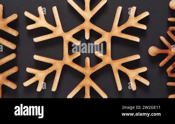 Handmade wooden snoflakes in flat lay video clip filmed directly from ...