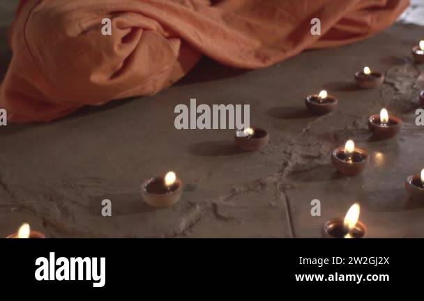 A monk in an ancient temple lights a sacred fire, the priestess brought ...