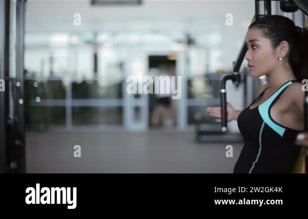 Young attractive asian woman in the gym. Footage by slider (dolly) left to right Stock Video ...
