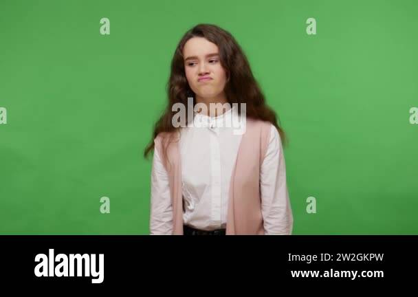 Upset adolescent brunette girl in white shirt worrying about teenage ...