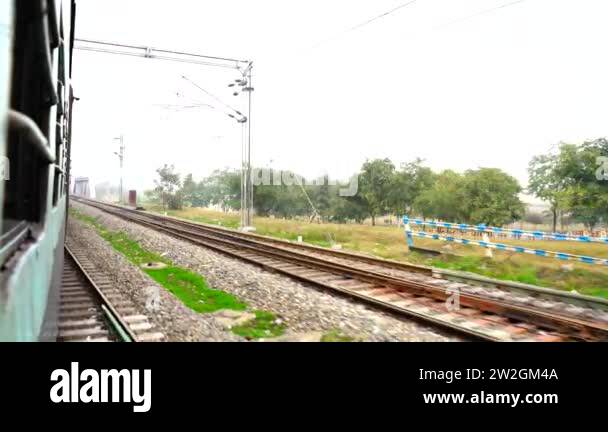 Indian Railways. Passenger train, by rail. Shot from window of last car ...