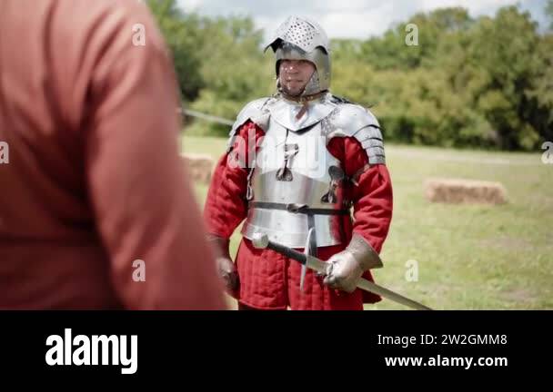 Medieval knight dressed in traditional heavy armor with metal sword ...